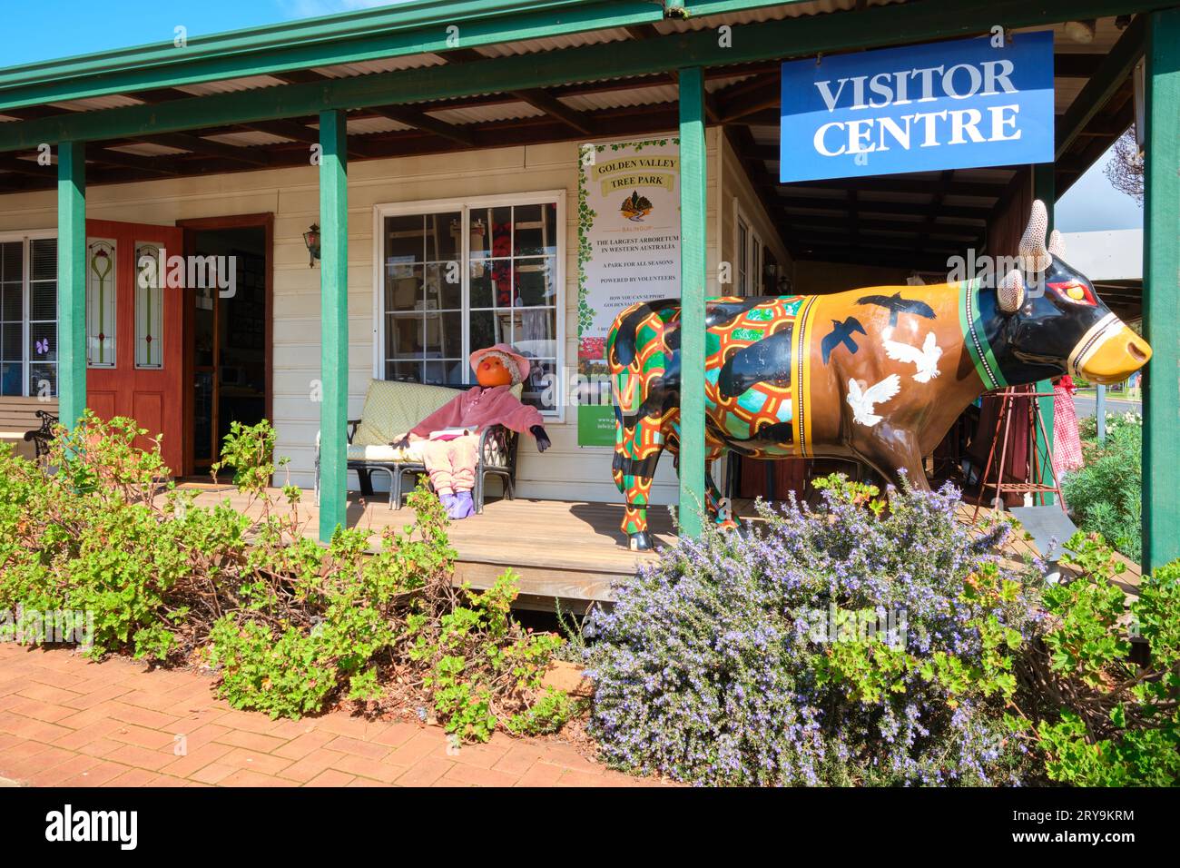 Balingup Visitor Centre with a painted cow sculpture and a scarecrow in ...