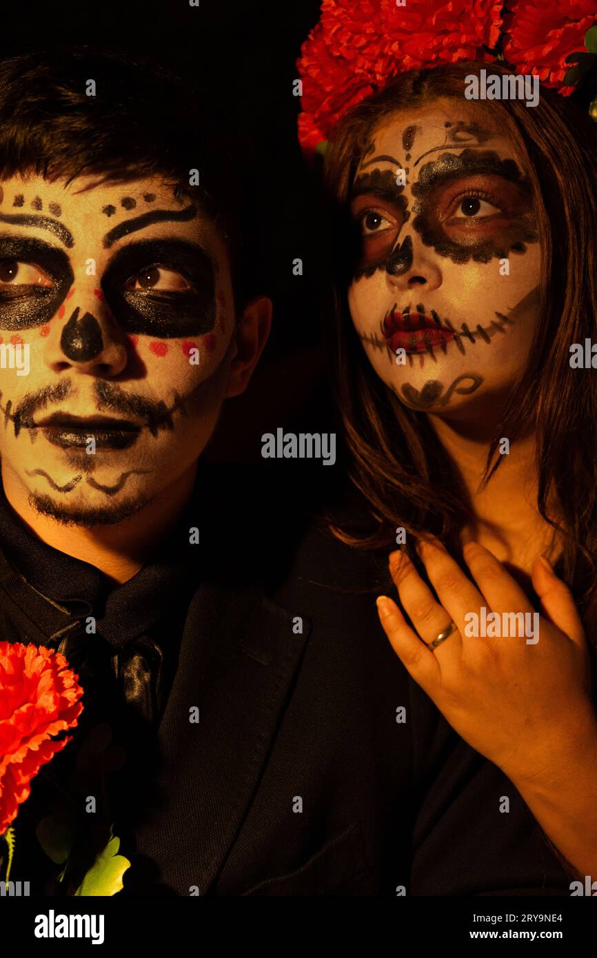 young couple dressed as catrin and catrina posing in a studio on a ...
