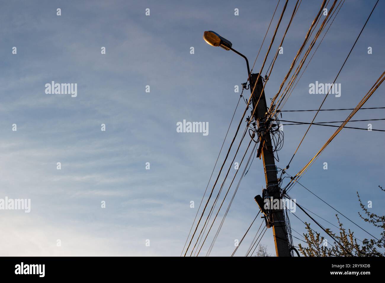 Power line support with many wires and street lamp Stock Photo - Alamy