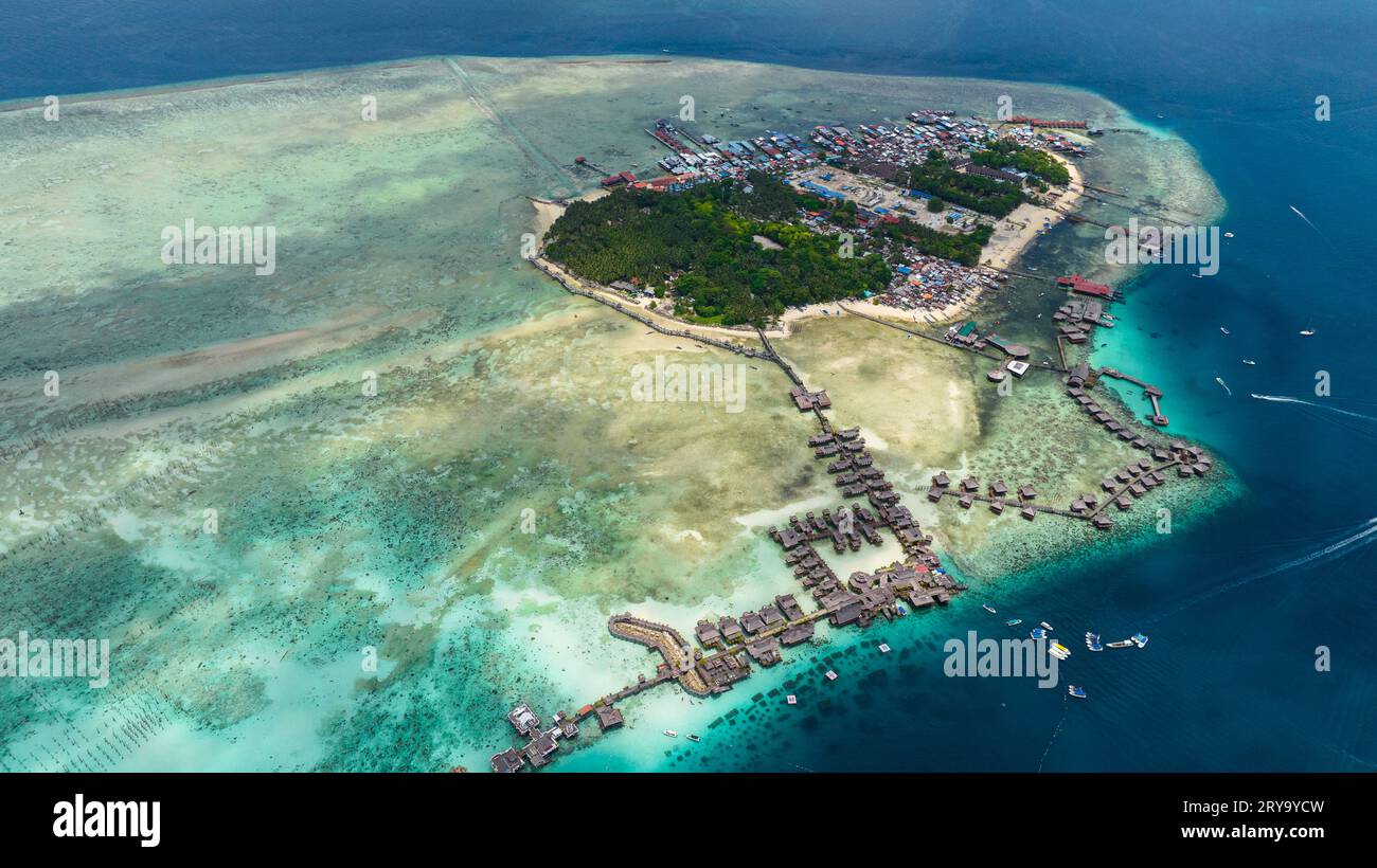 Tropical island Mabul in the blue sea with a coral reef and the beach ...