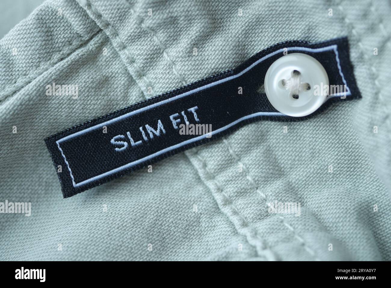 label tag slim fit on a men shirt Stock Photo - Alamy
