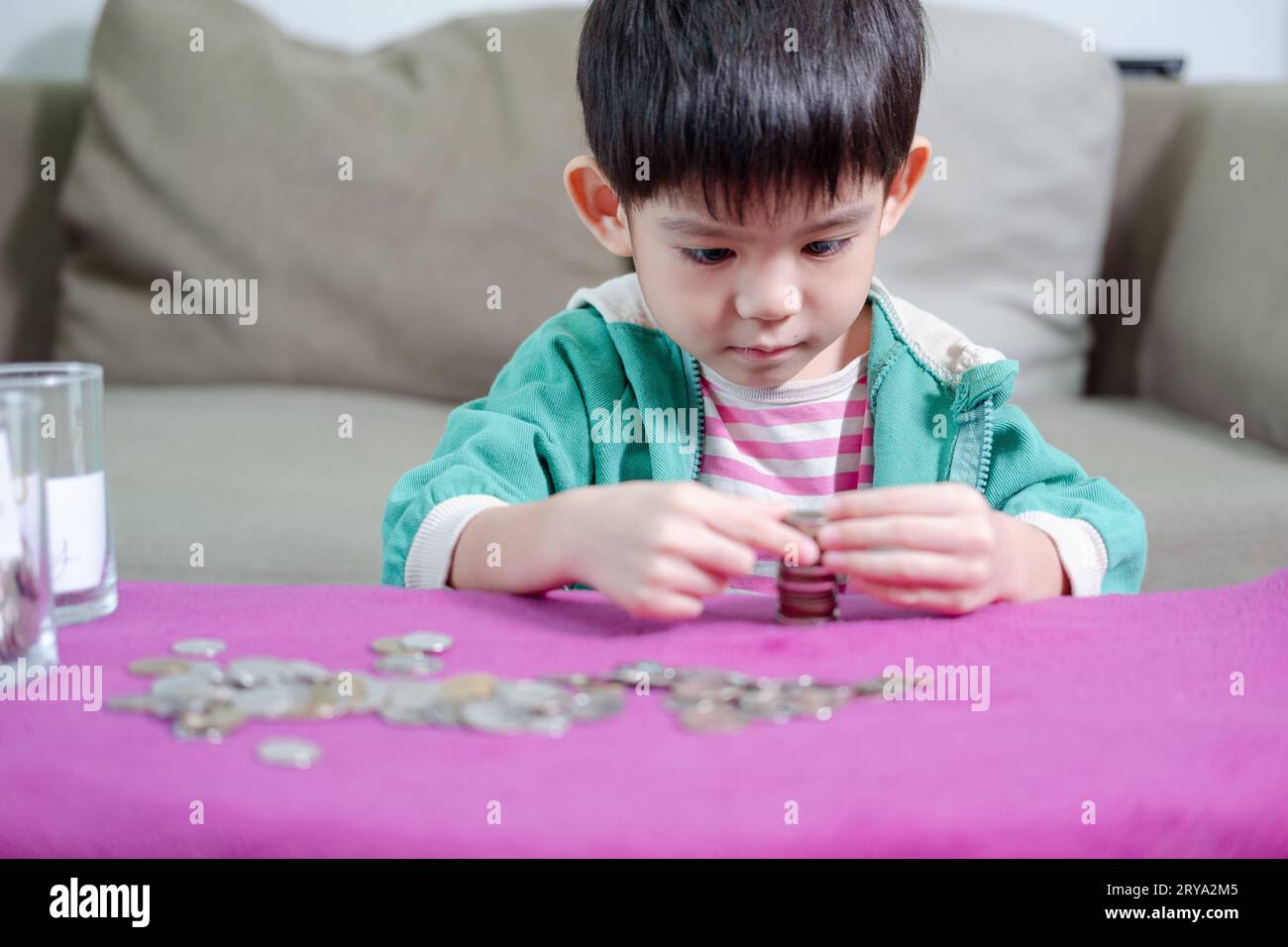 Boy counting coins hi-res stock photography and images - Alamy