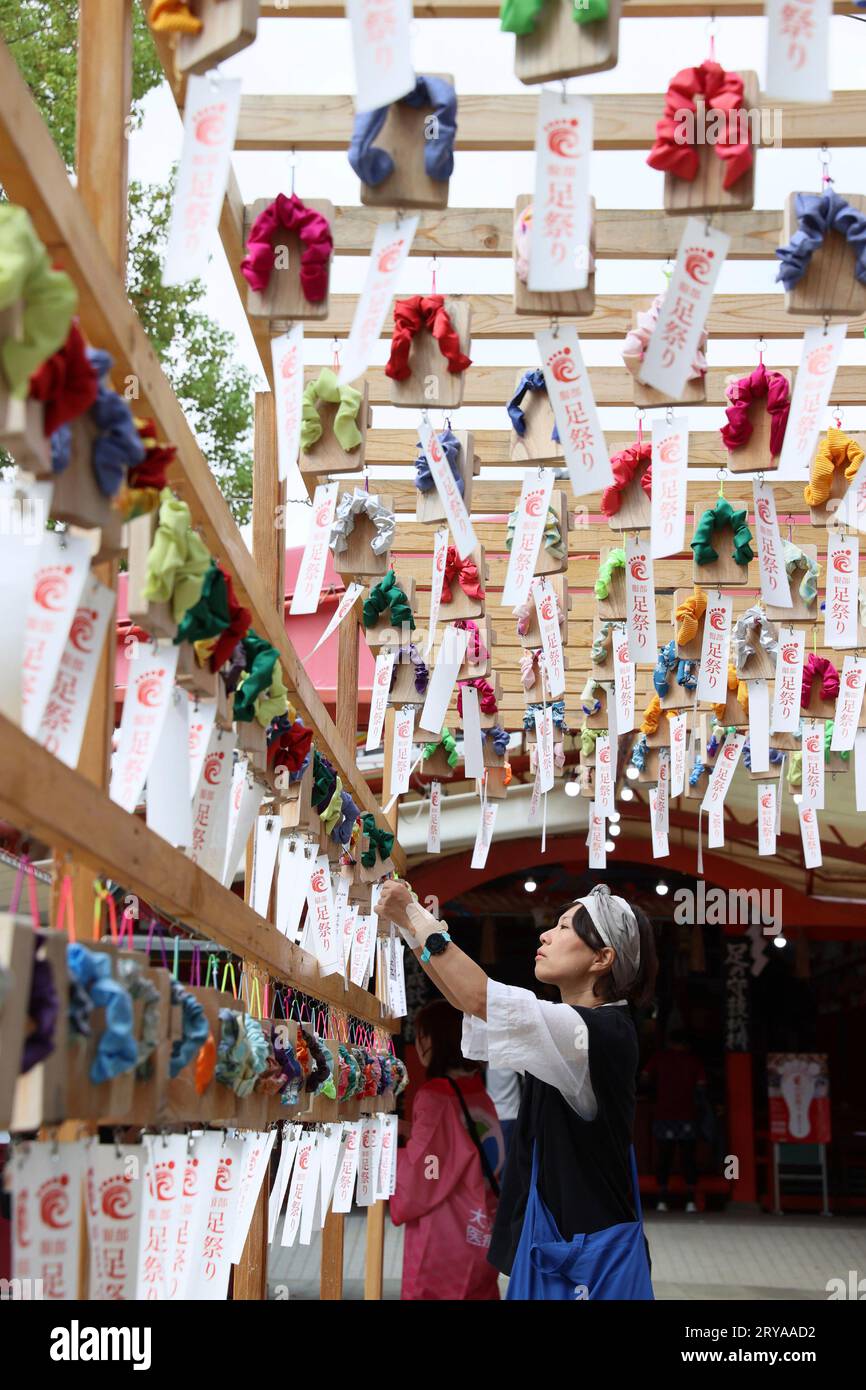 Geta, traditional Japanese footwear, with strips of paper with wishes ...