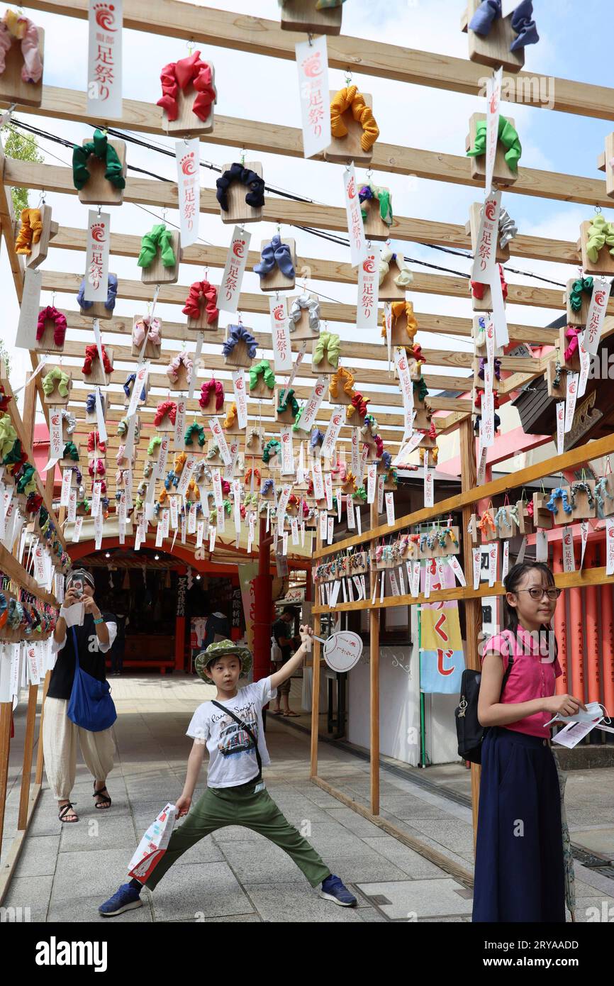 Geta, traditional Japanese footwear, with strips of paper with wishes ...