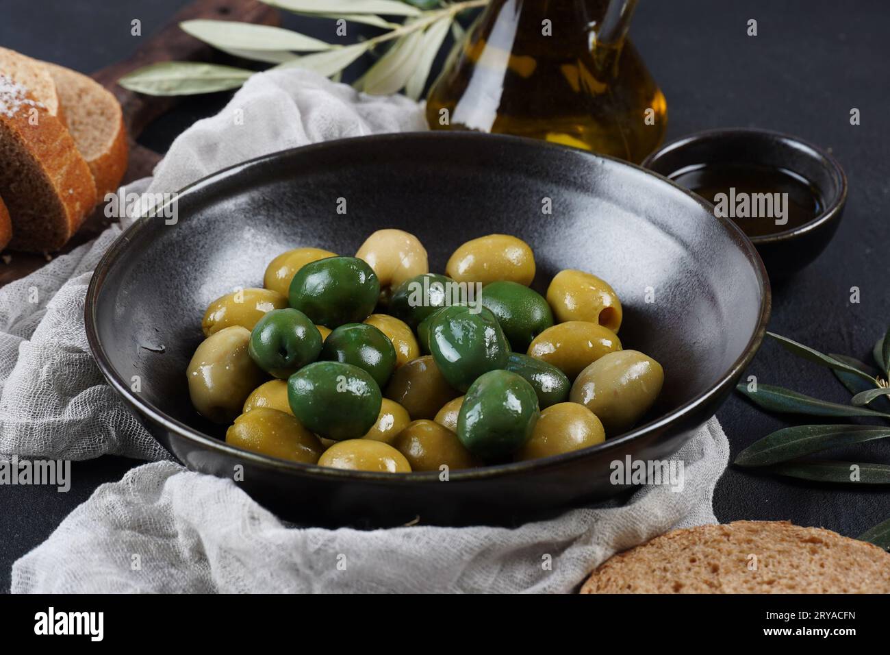Colorful Olives in dark plate ready for dinner Stock Photo - Alamy