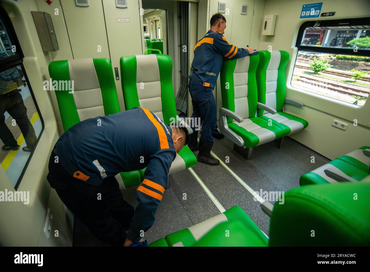 FEEDER TRAIN TEST RUN Officers clean the passenger seats of a feeder ...