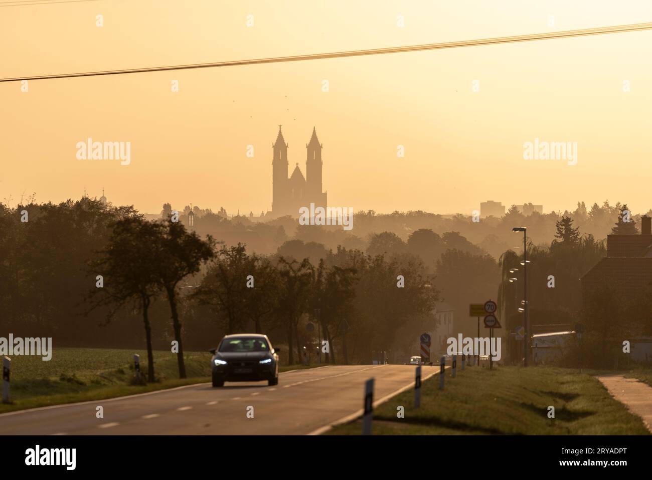 Magdeburg Cathedral rises on the horizon in the light of the rising sun ...