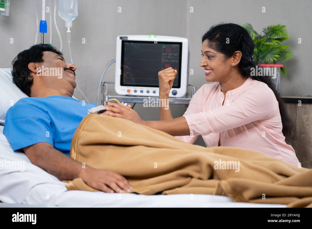 Smiling Indian middle aged wife or women giving confidence to sick ...