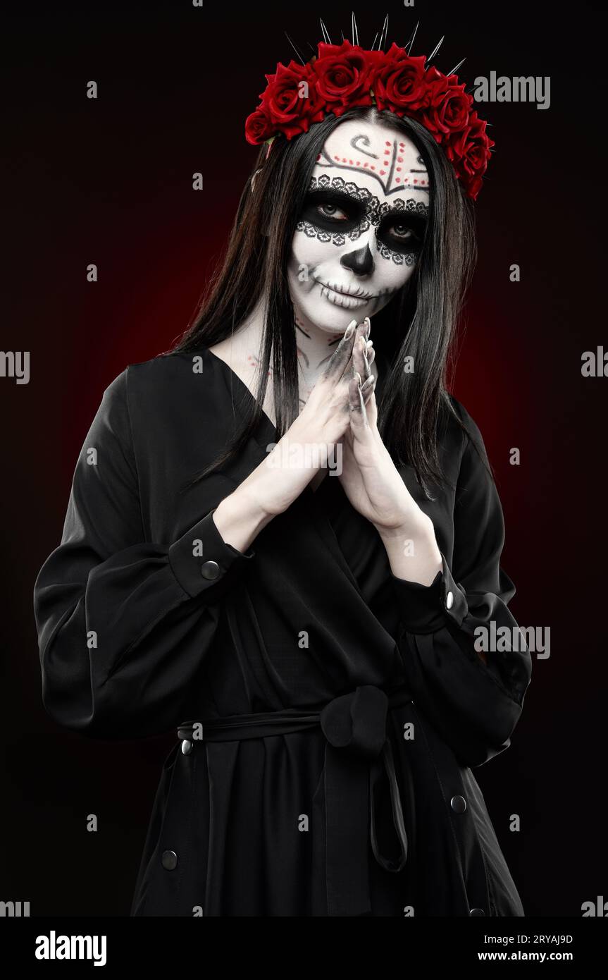 Young woman with calavera (sugar skull) makeup. The witch girl with ...