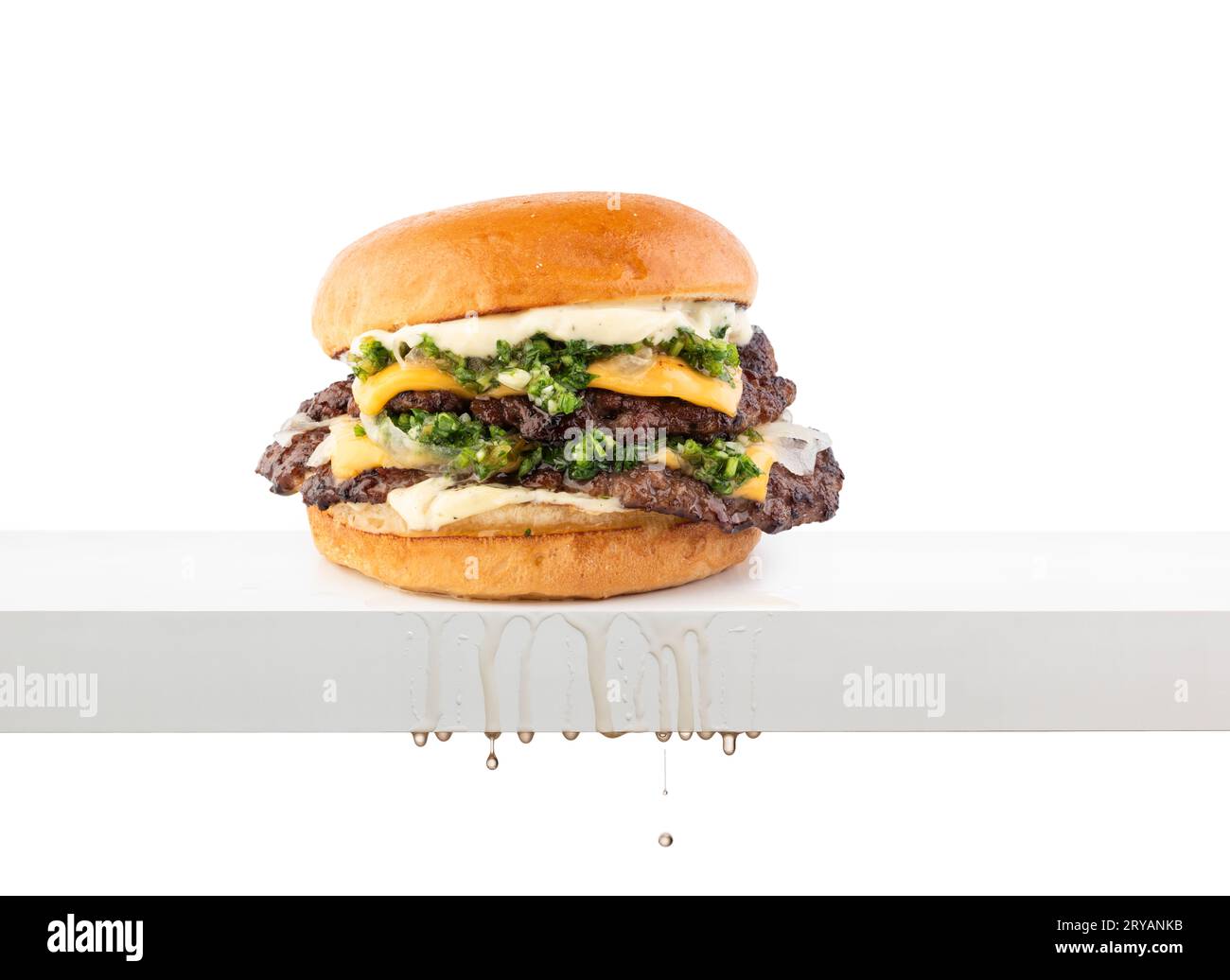 Classic hamburger with grilled meat and dripping sauce on white shelf ...