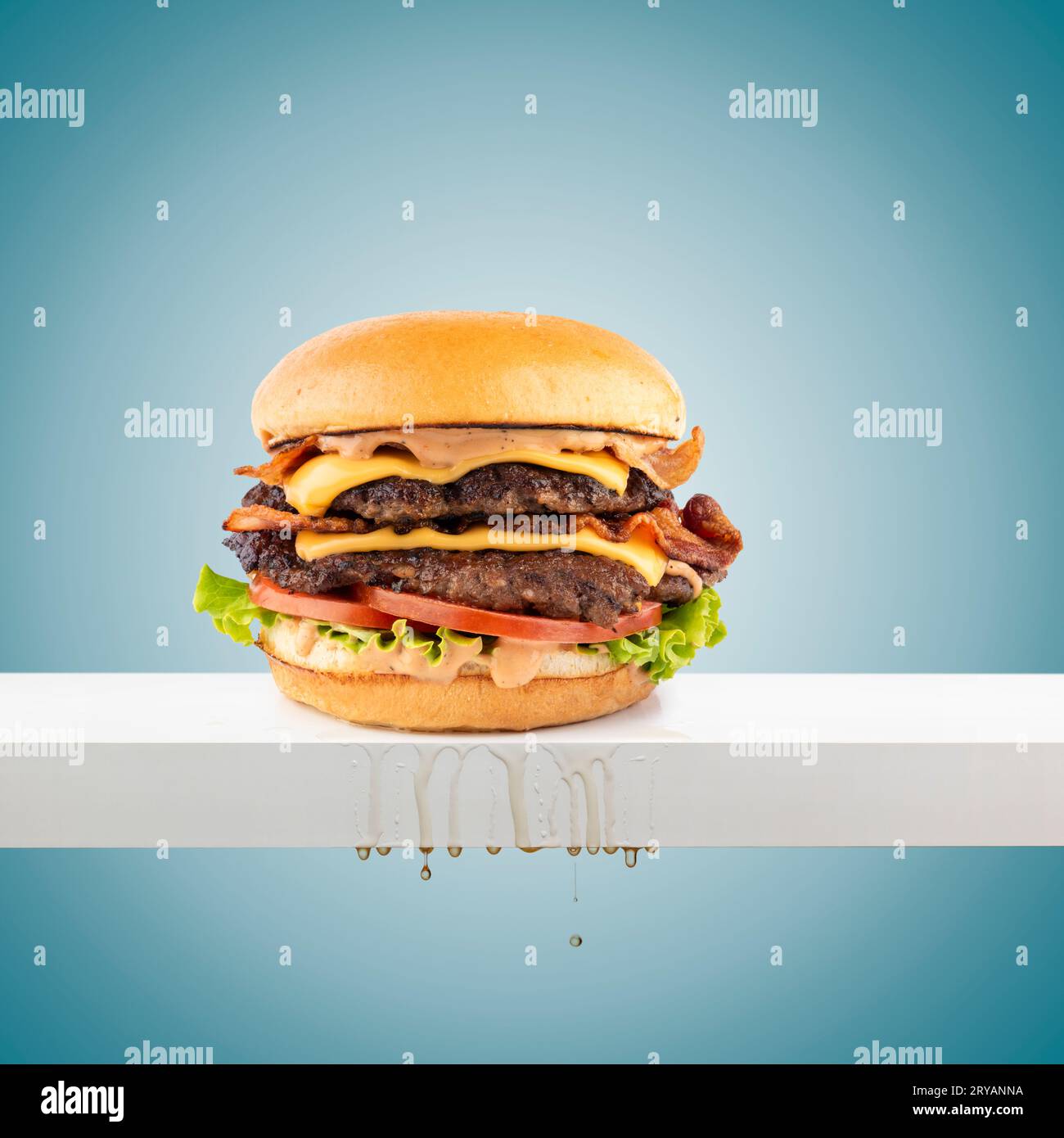 Classic hamburger with grilled meat on shelf with dripping sauce, on ...