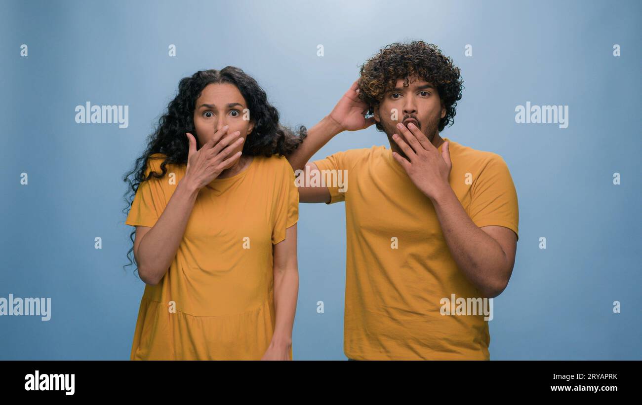 Multiracial shocked scared afraid couple amazed shocked Hispanic woman ...