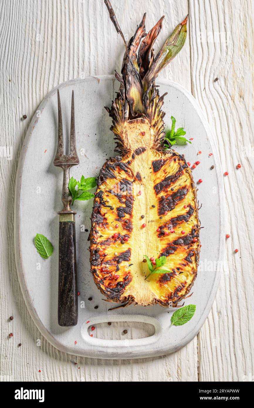 Grilled pineapple with mint and red pepper. Grilled ananas on grate ...