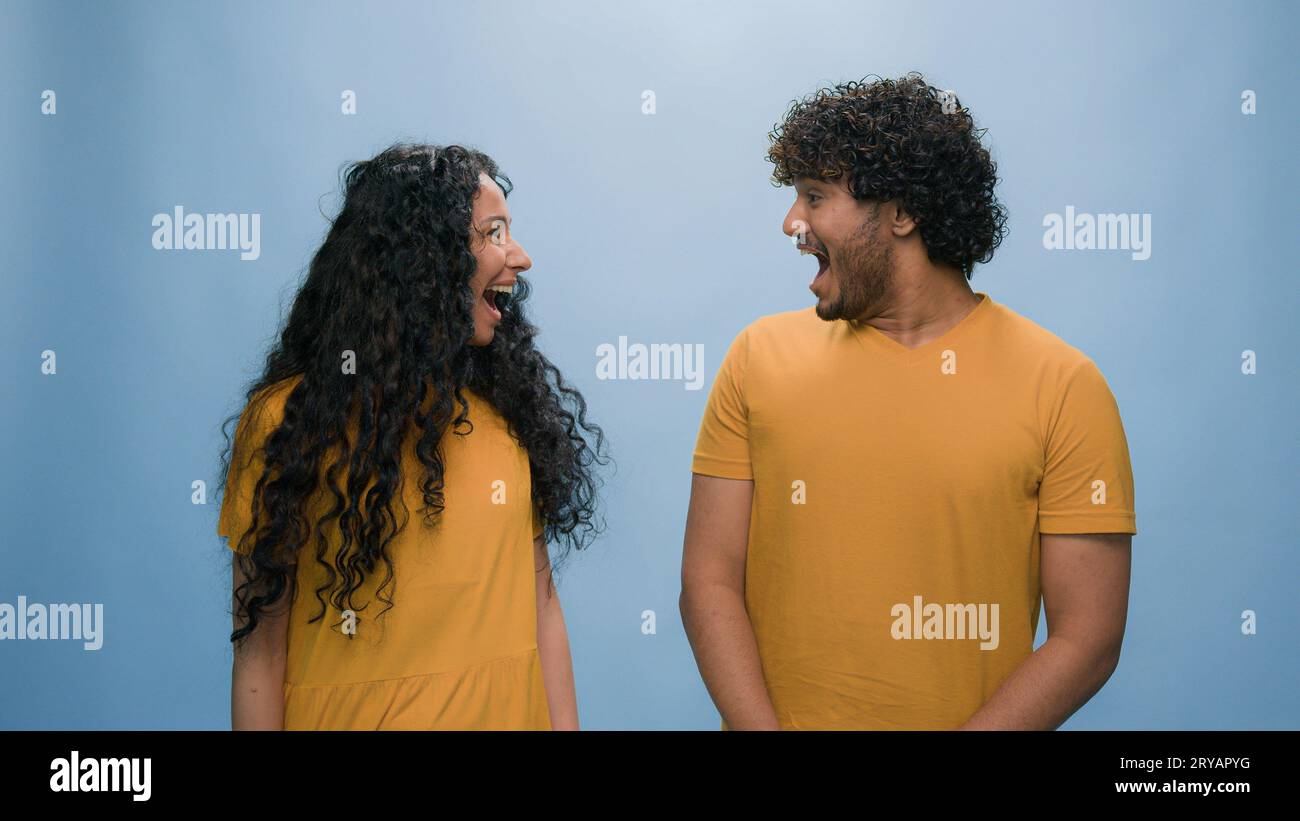 Portrait in blue background studio diverse multiracial couple looking ...