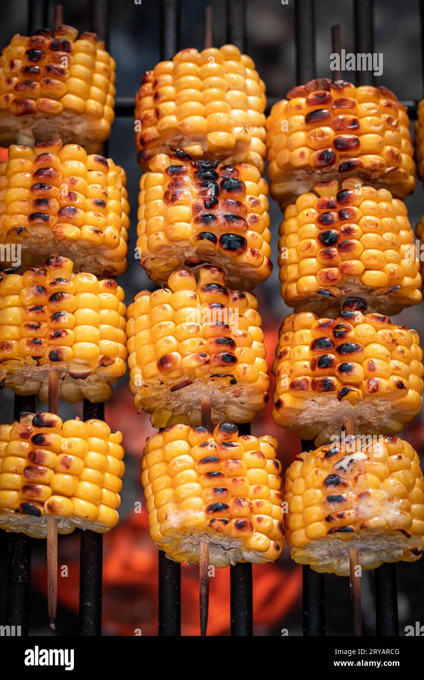 Tasty corncob on grill with melting butter and salt. Grill and baked ...