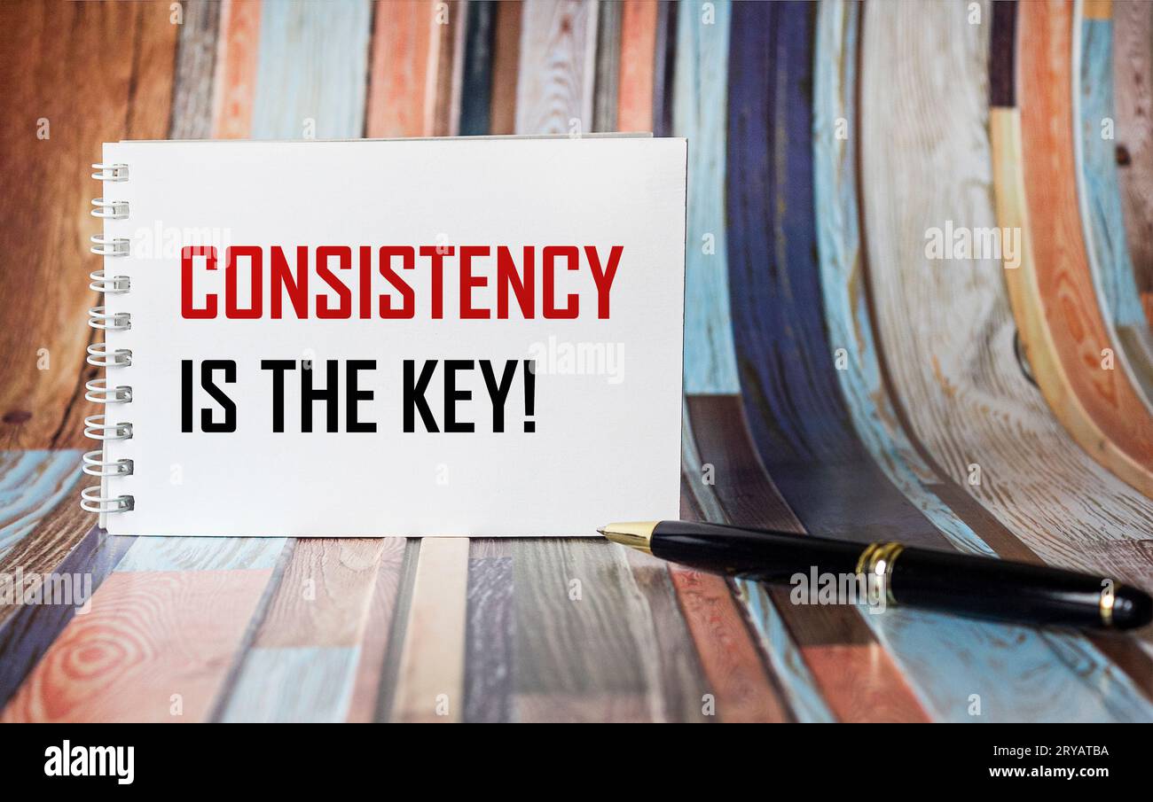 Notepad on vintage background with text Consistency is the key Stock ...