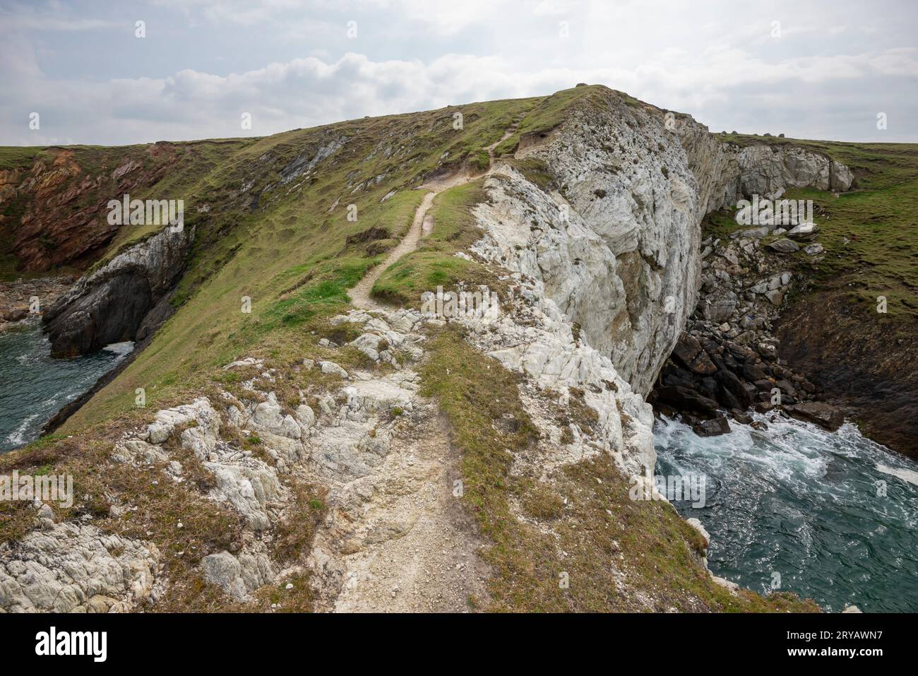 On top of the rock arch 'Bwa Gwyn' on the coast near Rhoscolyn ...