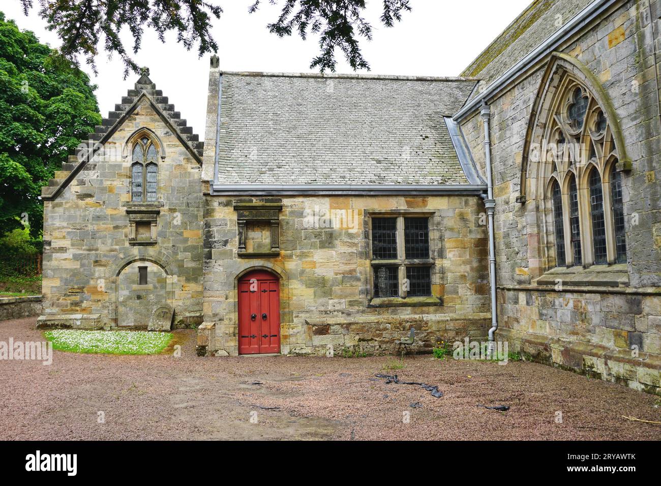Bright red door contrasts with natural stone at the Old Parish Church ...