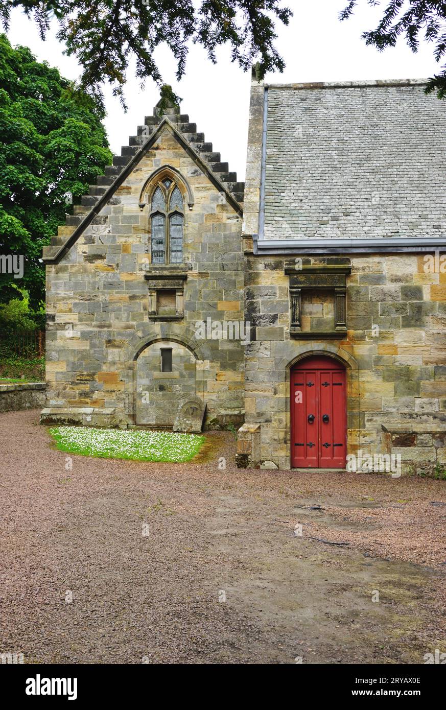 Part of the Old Parish Church, Culross, Scotland. The bright red door ...