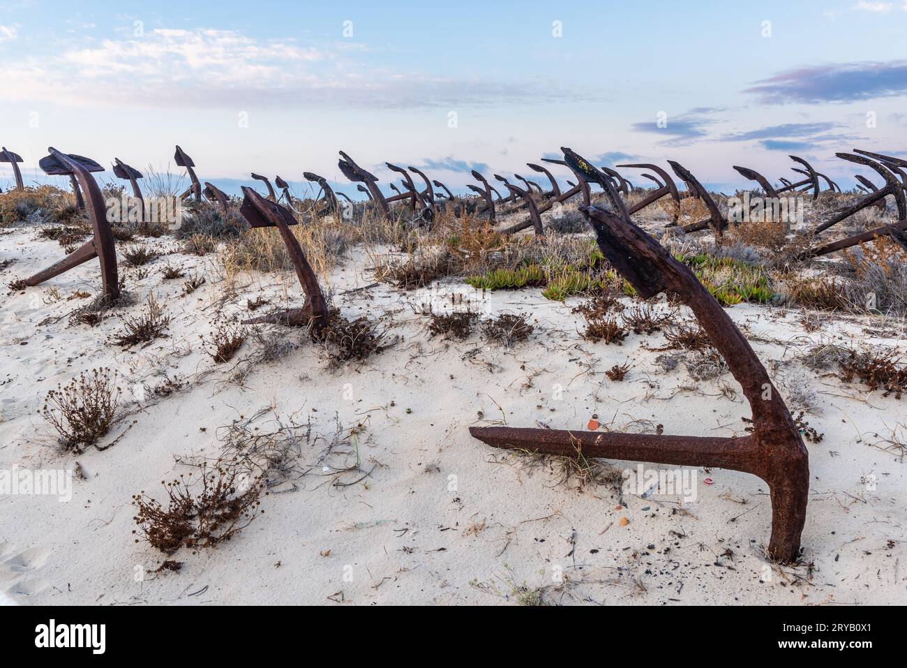 Rusty old anchors on the beach at the Anchor Cemetary graveyard at ...