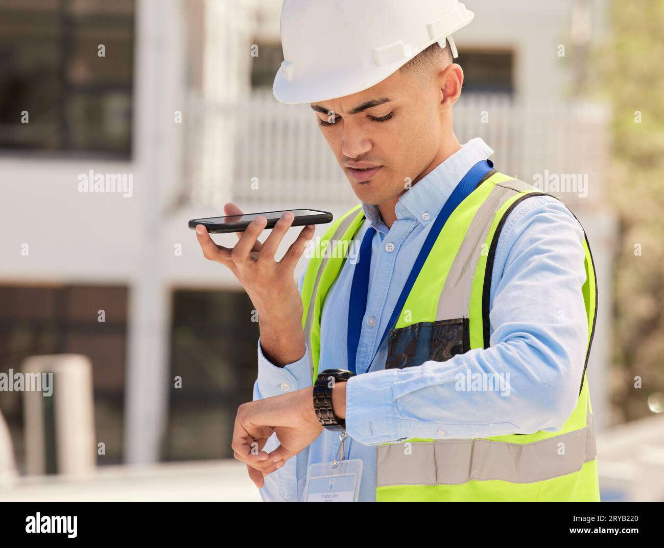 Engineer on construction site, phone call and checking watch for ...