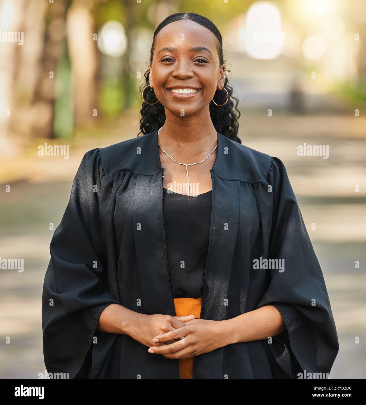 Portrait, graduate and happy black woman at university at campus ...