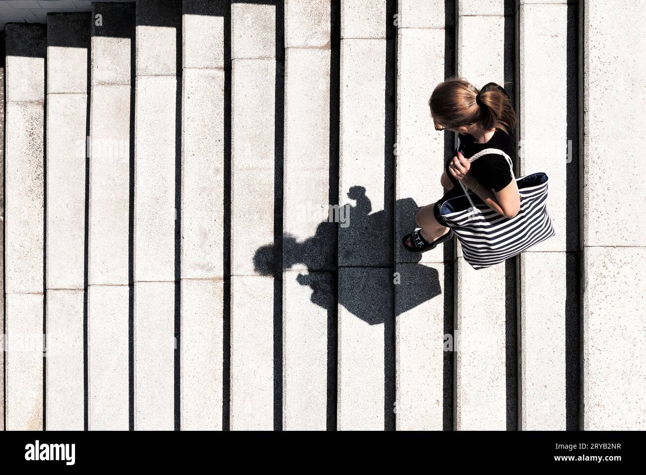 Woman walking down stairs- top view Stock Photo - Alamy