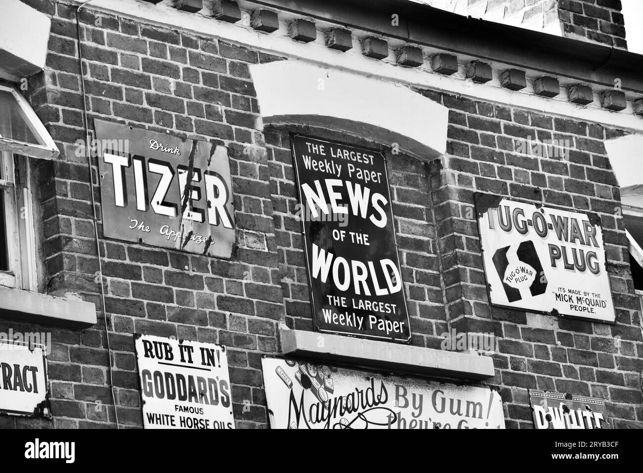 Black and white photo of a collection of vintage metal advertising ...