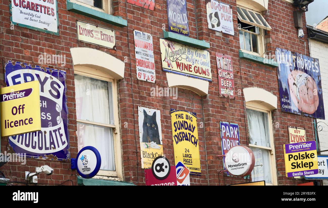 A colourful collection of vintage metal advertising signs displayed on ...