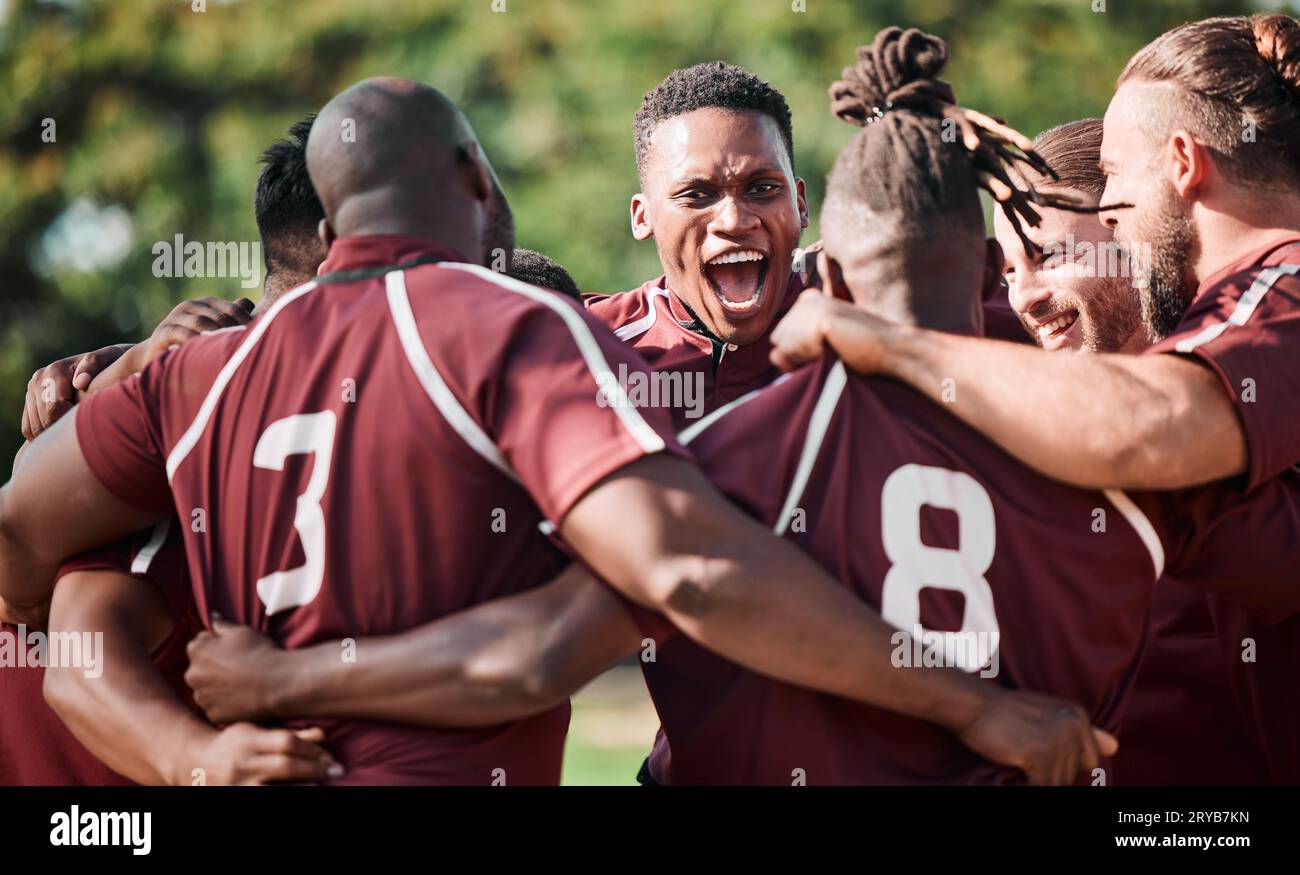 Football team, hug in circle and happy on sports field with shout ...