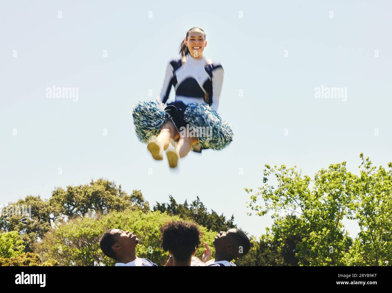 Sports, portrait and woman cheerleader in air on a field for motivation ...