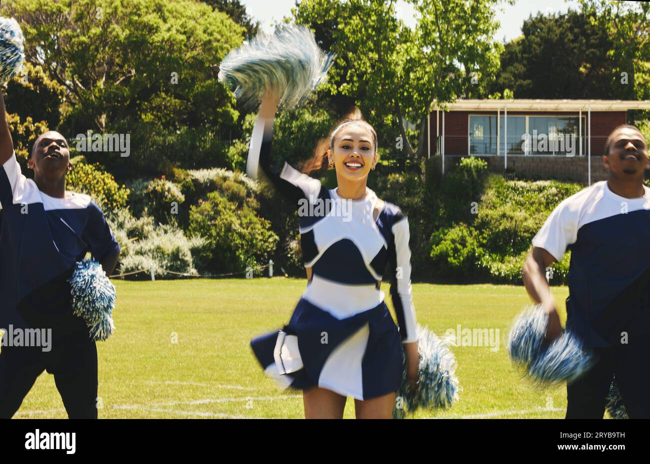 Cheerleader, team and people dancing on sports field at university ...