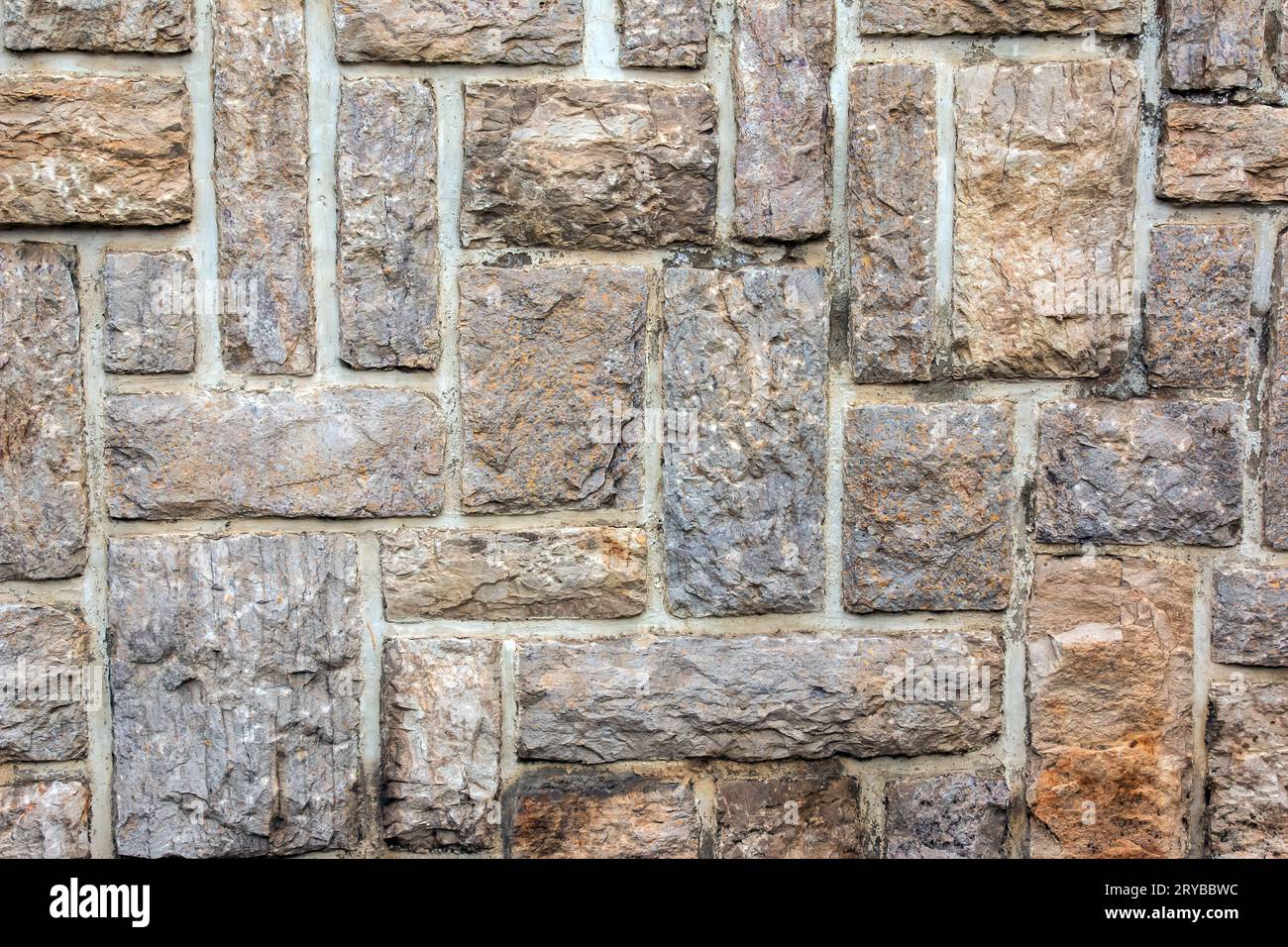 Cobble brown stone siding tile wall abstract background. House exterior ...