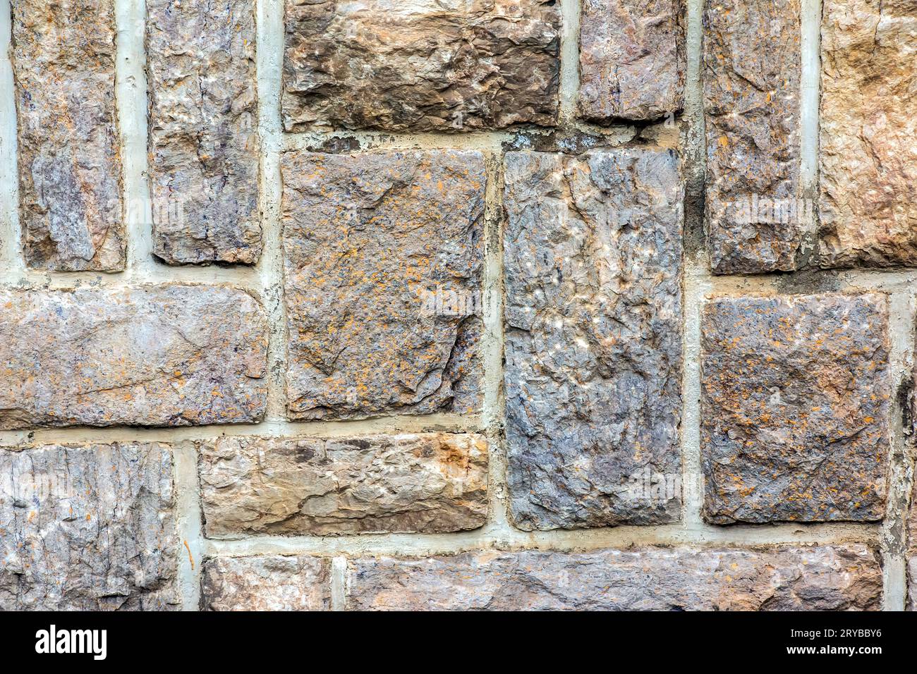 Cobble brown stone siding tile wall abstract background. House exterior ...