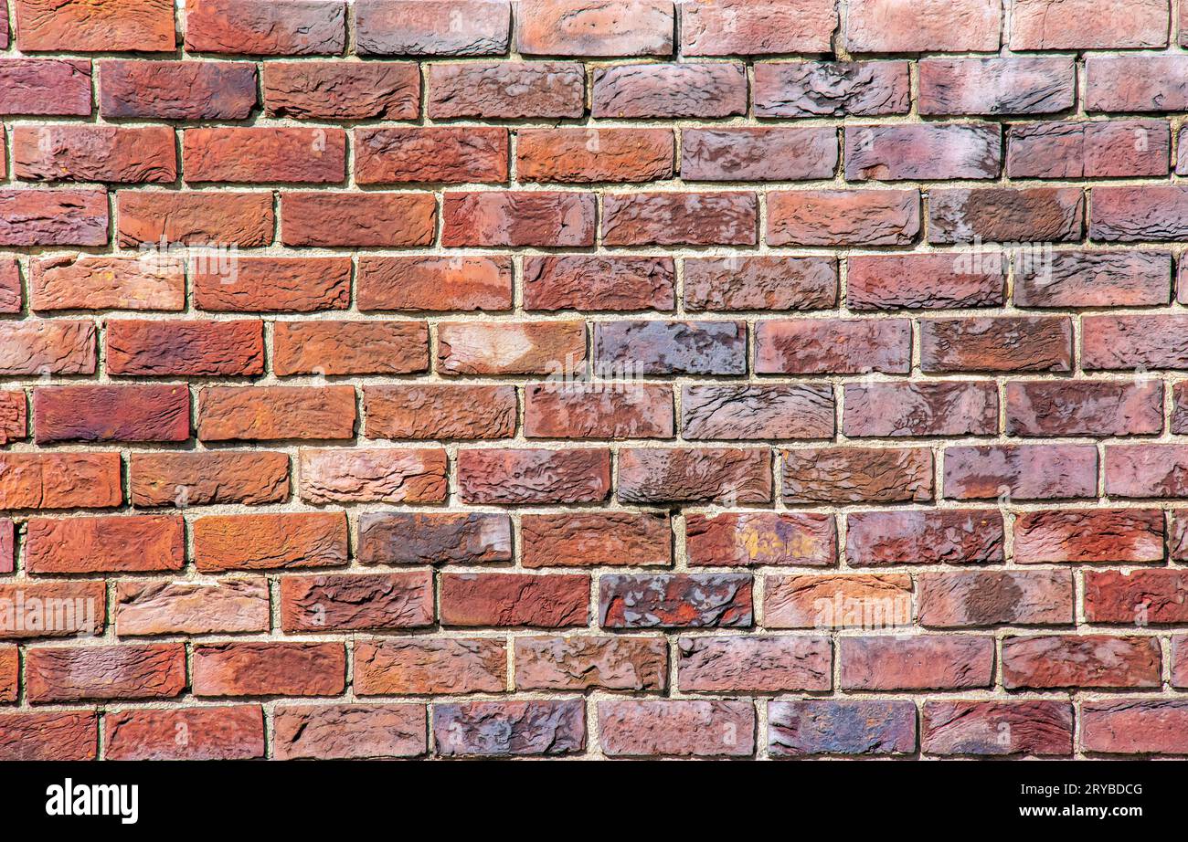 Brick tile wall abstract background. Exterior view of a house made of blocks lined with cement ...