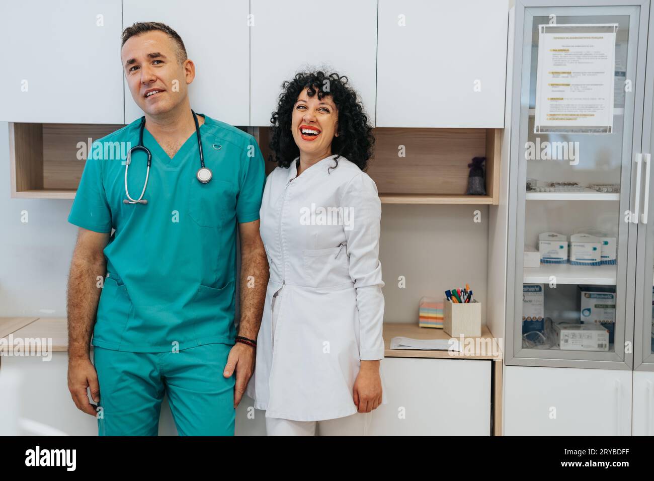 Good looking middle-aged male doctor posing with gorgeous female doctor ...