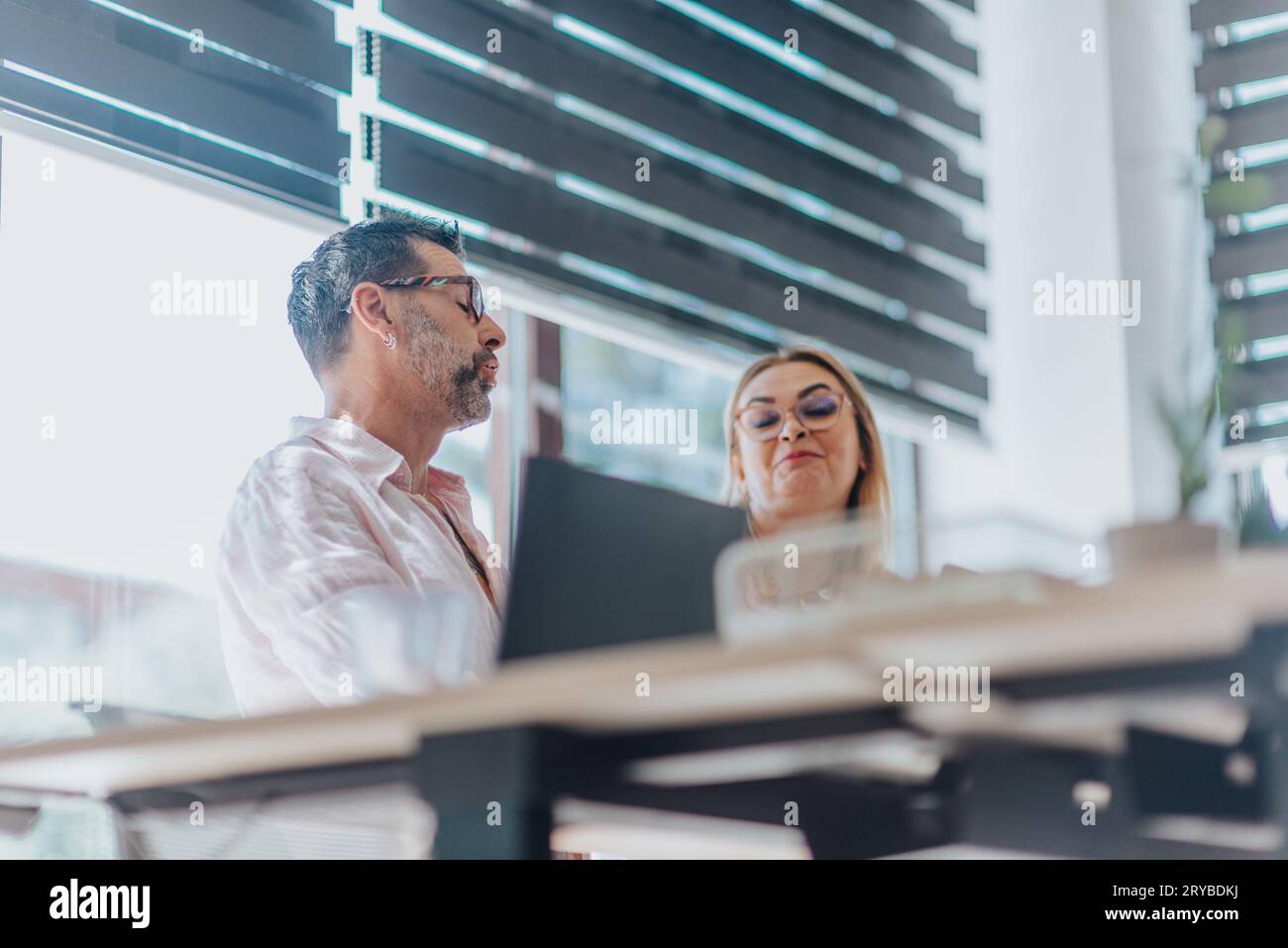 A successful marketing partners collaborates in a modern office ...