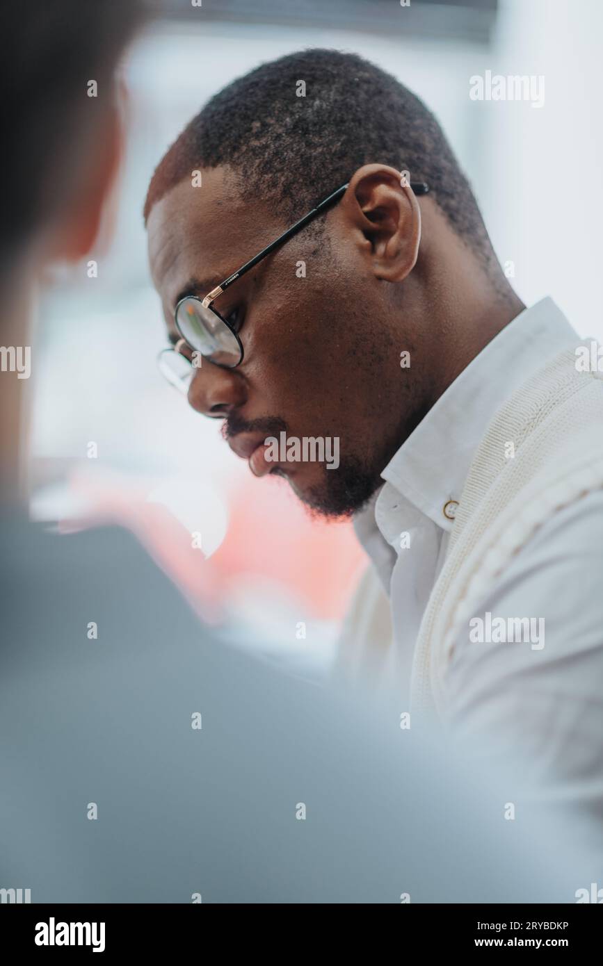 Concentrated male employee reviewing paperwork at the office Stock ...