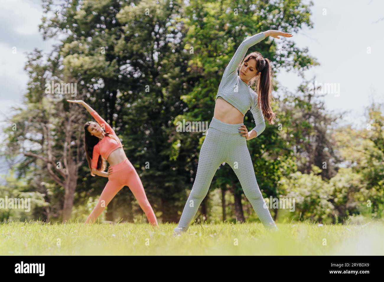 Fit, active women train together in an urban park, enjoying their sport ...