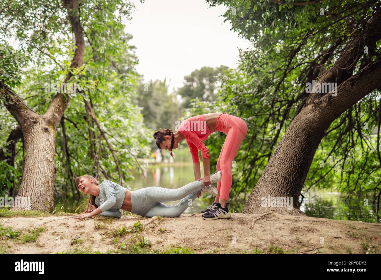 Fit and attractive sportswomen engage in a rigorous outdoor workout ...