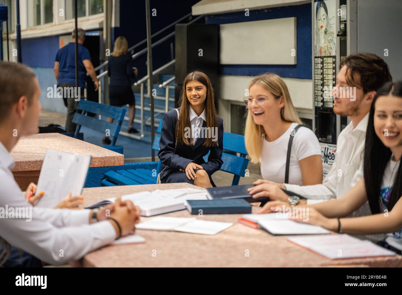 A diverse group of university students discussing and exchanging ideas ...