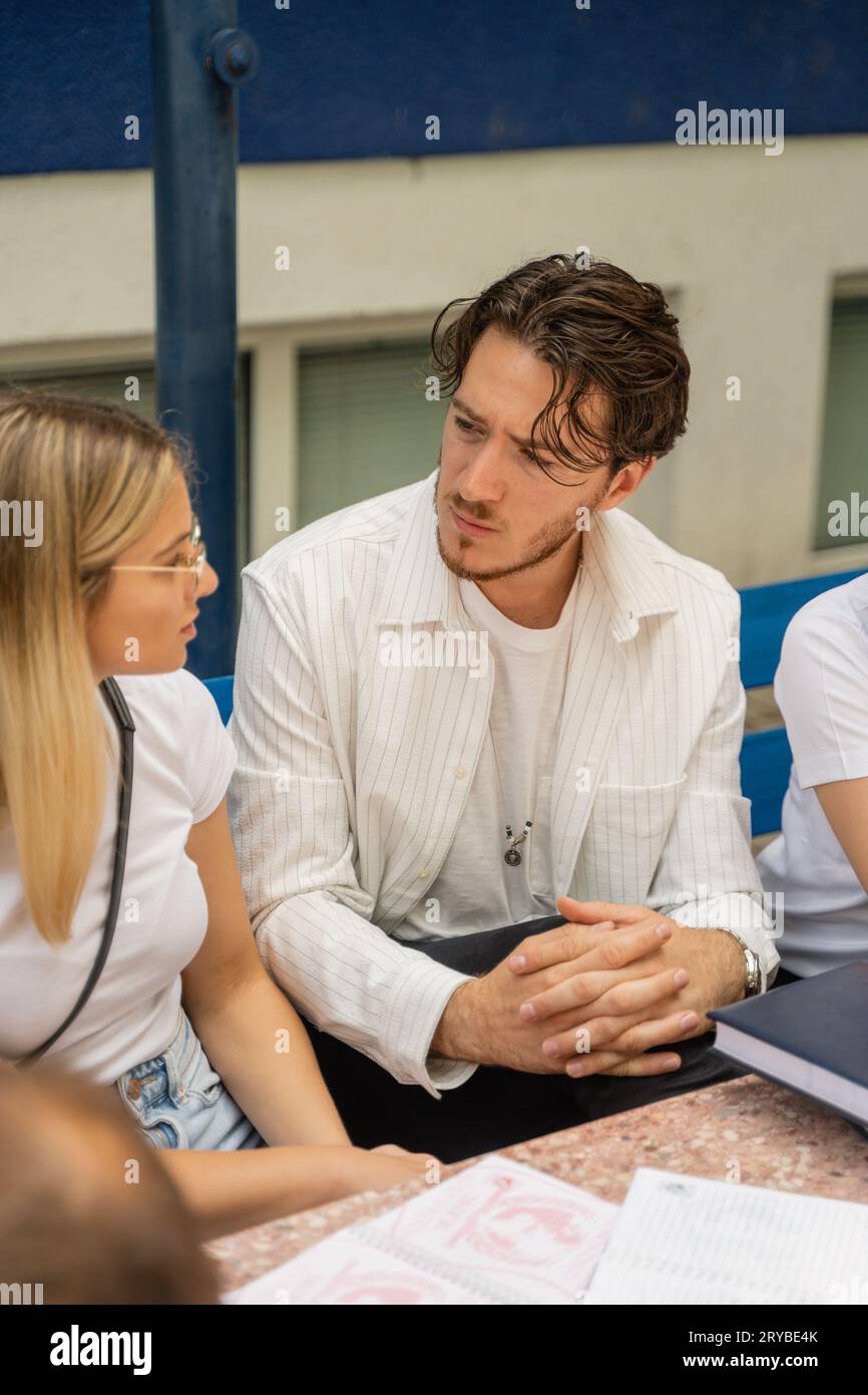 Group of diverse university students having a lively academic debate ...