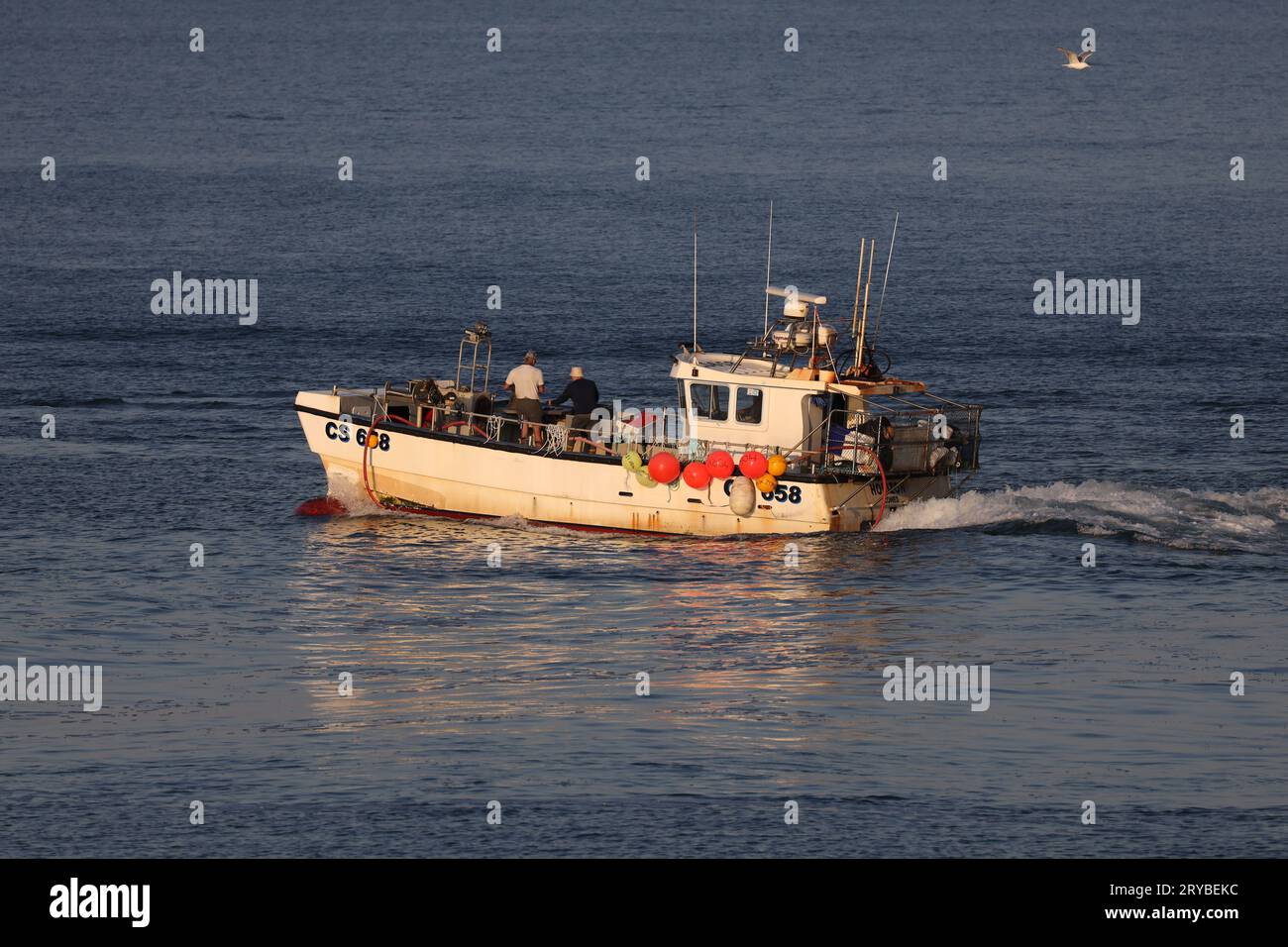 Early morning sunshine bathes the vessel HORIZON (CS658) as it heads to local fishing grounds in ...