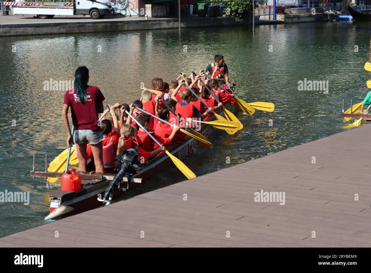 Young rowers practice with their teacher in the waters of the canals ...