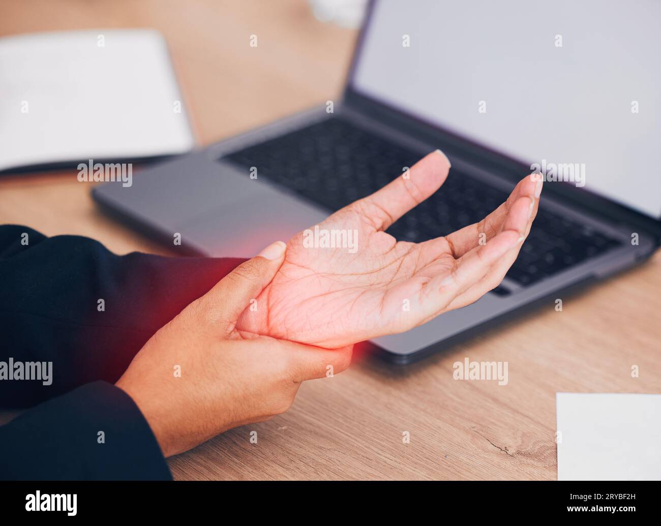 Wrist, pain and business woman with laptop, mockup or screen in office ...