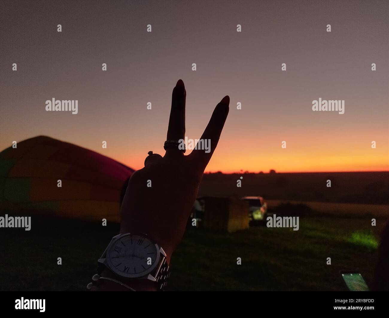 Female hand doing a peace sign in the sunrise Stock Photo - Alamy