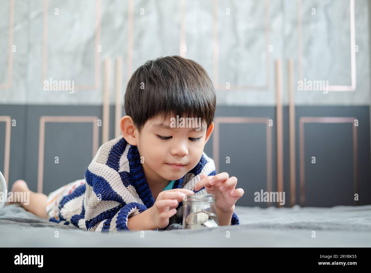 Asian boy happily counting coins to save money Stock Photo - Alamy