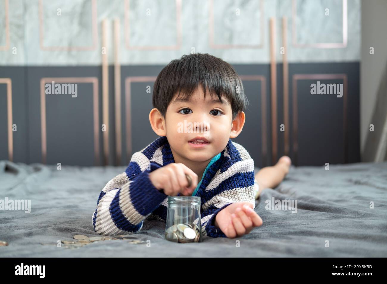 Asian boy happily counting coins to save money Stock Photo - Alamy