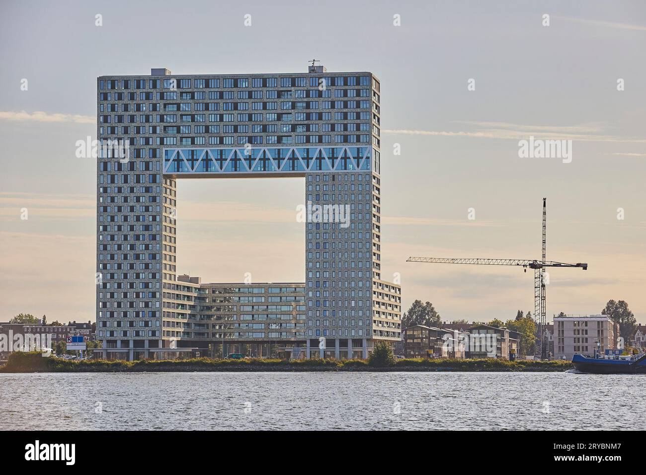 Unusual building in Amsterdam on the shore at sunset Stock Photo - Alamy