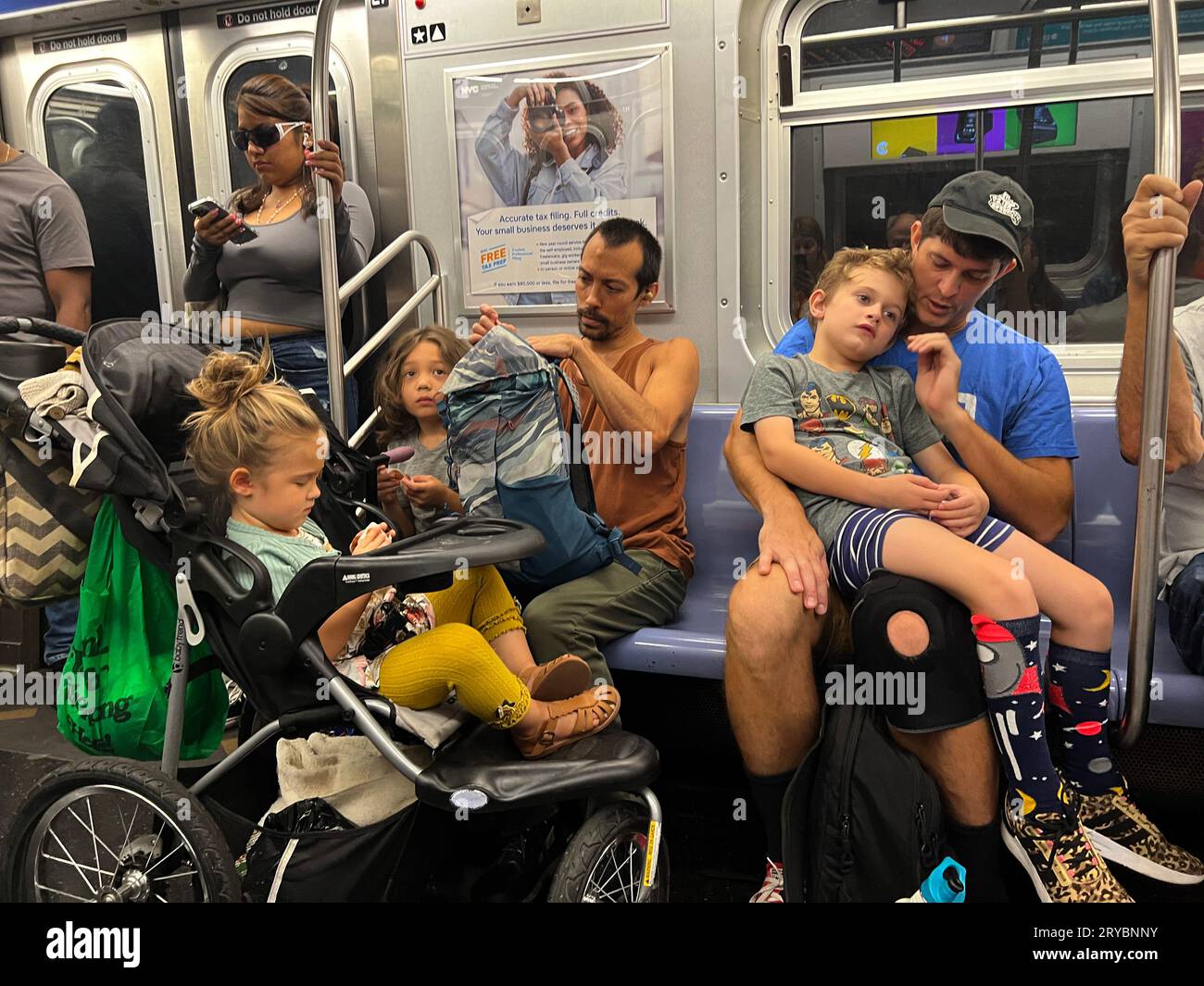 Fathers with children ride a New York City subway Train in New York ...